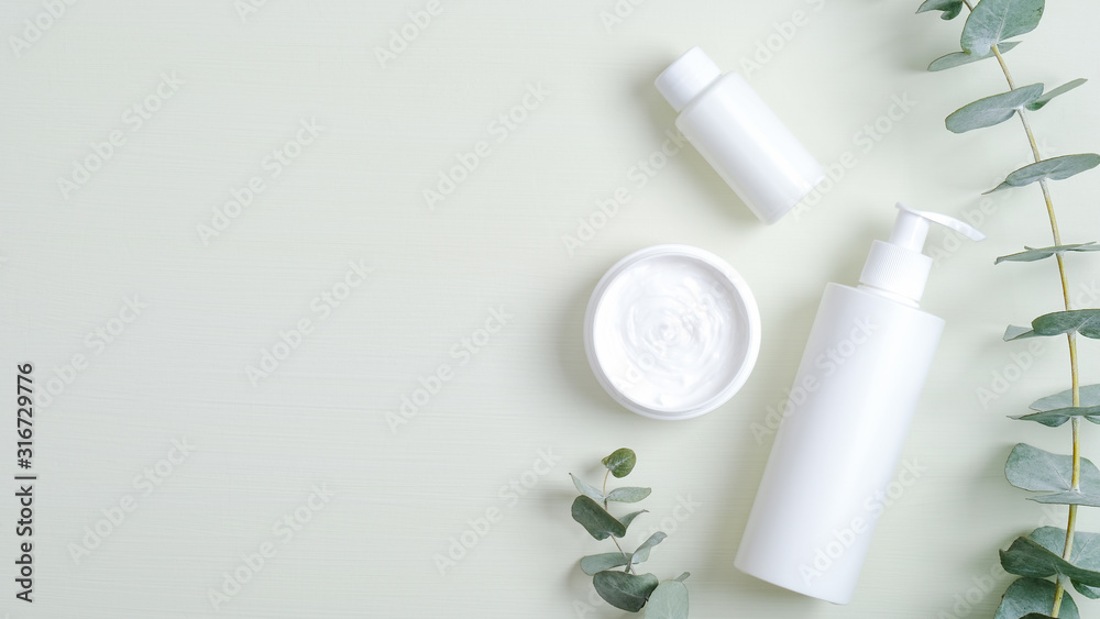 Frame of organic cosmetic products and eucalyptus leaves. Top view hand ...