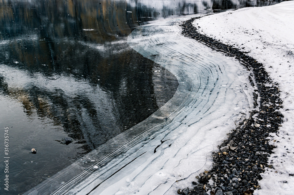 shore line with ice structure and beautiful lines on frozen lake Stock ...