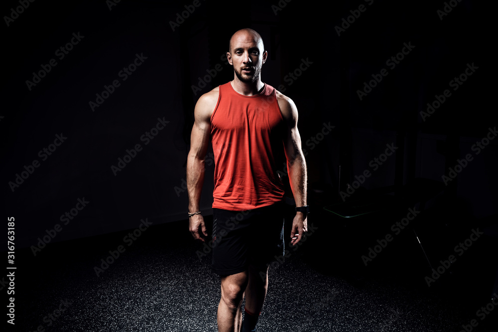 Strong muscular bodybuilder athletic man looking at camera while ...