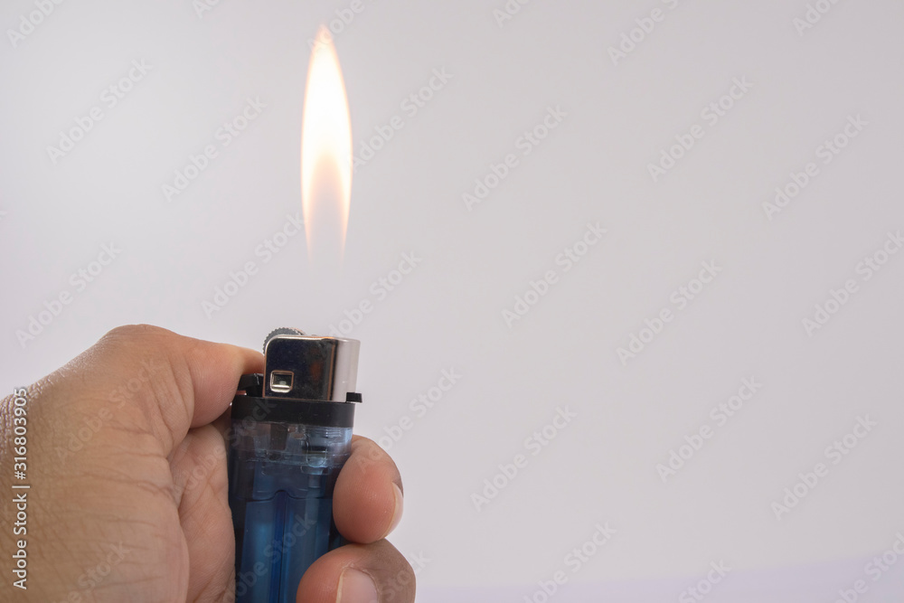 The blue lighter in his hand was lit, with a flame burning towards him ...