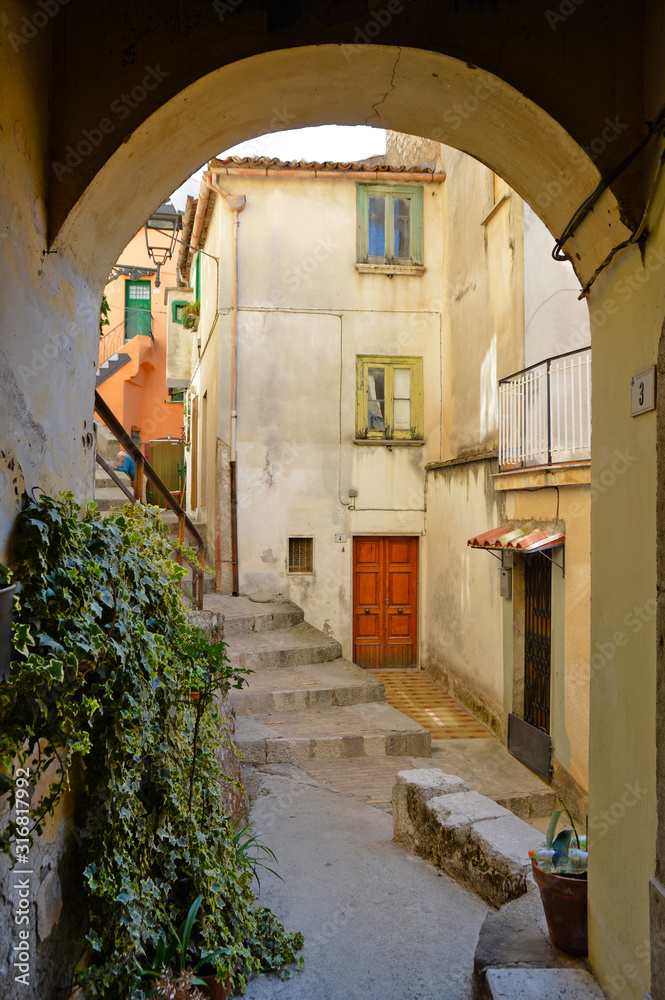Castelcivita, Italy. A narrow street between the old houses of a ...