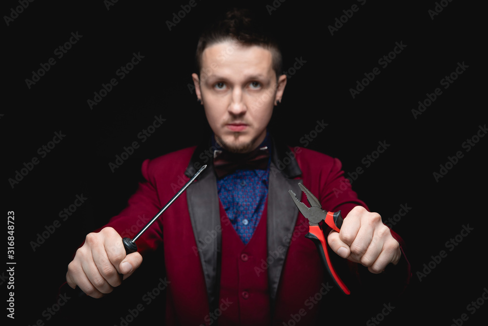 Male magician is experimenting with magic wands using screwdriver tool ...