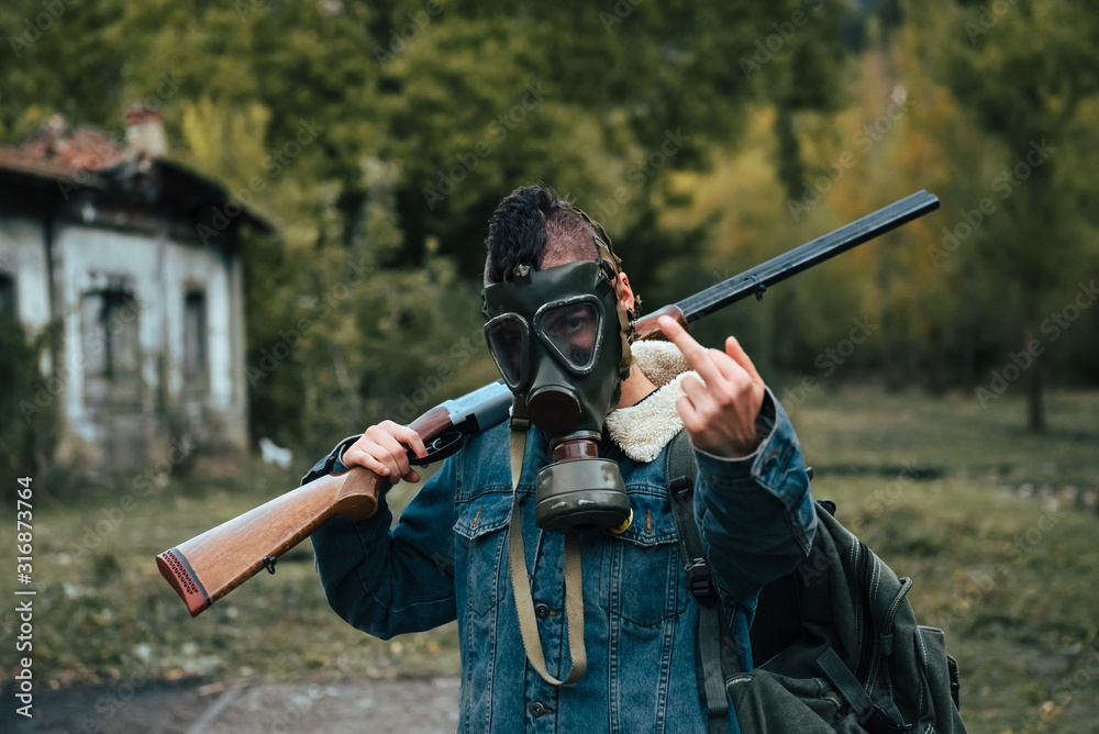 woman with punk style, with gas mask, backpack and double barrel ...