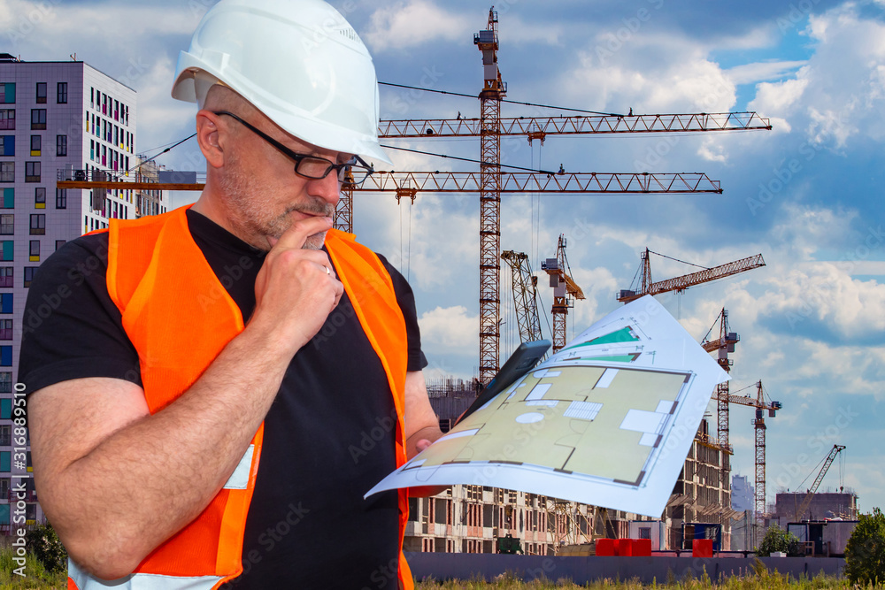 Build. Man in a helmet at a construction site. Real estate business ...