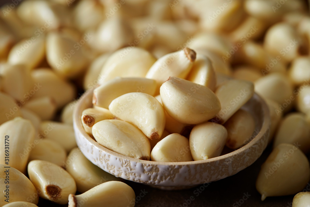 Peeled garlic background, studio shot Stock Photo | Adobe Stock