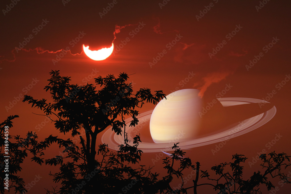 half sunset sky back on red cloud and colse up to rings of saturn over ...