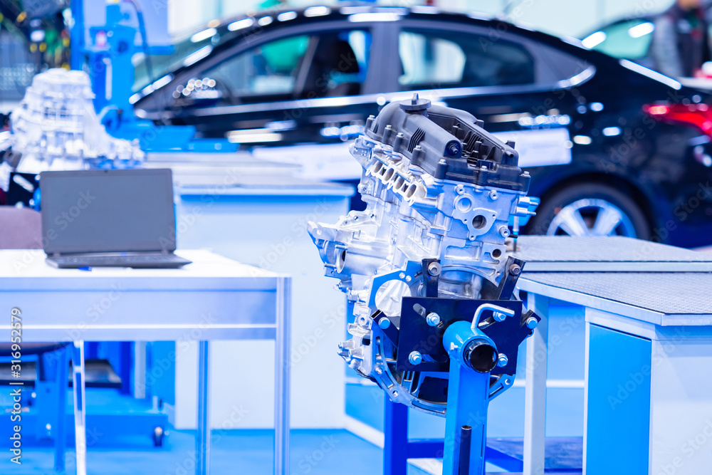 Car engine next to a laptop. Computer diagnostics of the motor ...