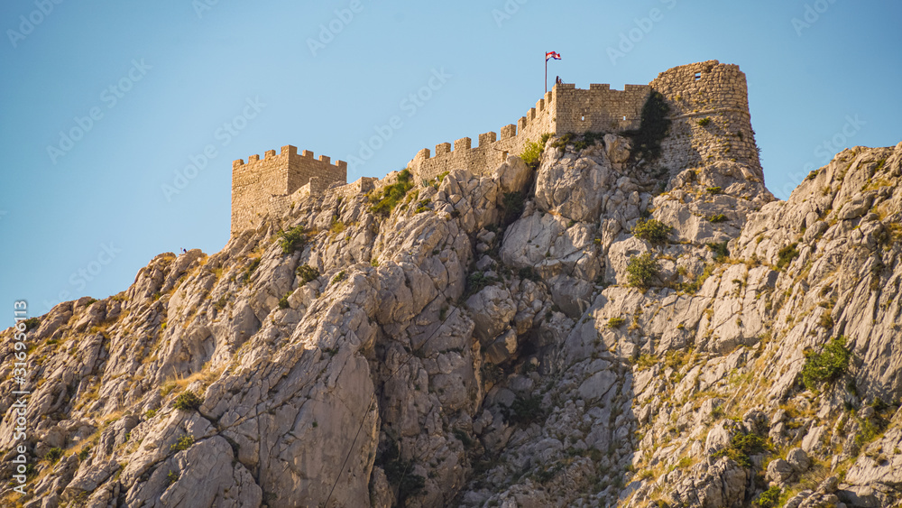 The evening sun illuminates the medieval pirate fortress Stari Grad ...