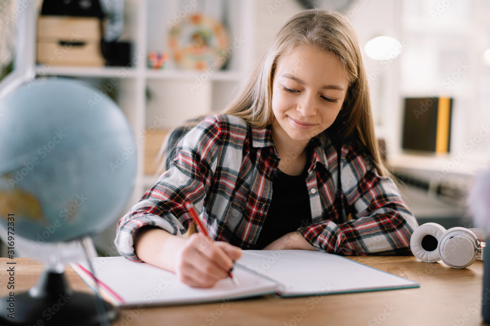 Young girl doing homework. Beautiful little girl at home learning Stock ...