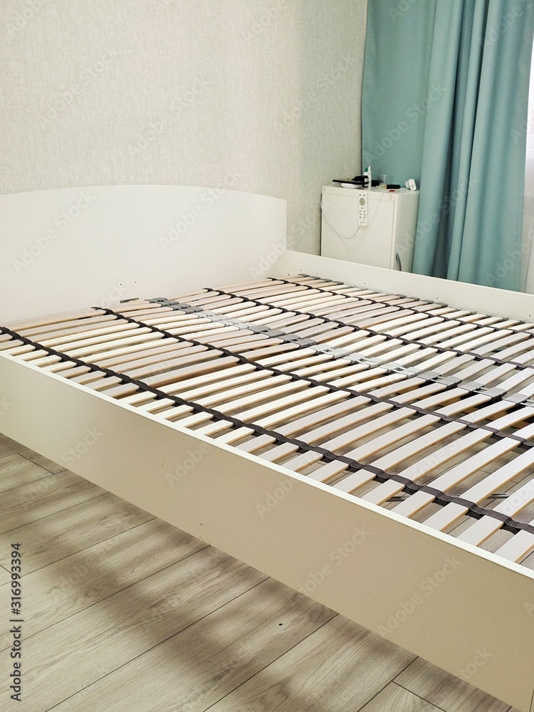 bed with orthopedic wooden base. assembling a bed in a room. Stock ...