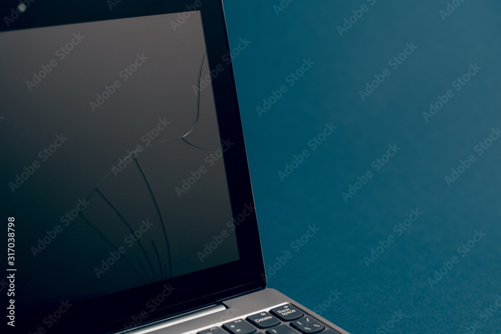 The screen laptop cracked and damaged. A silver laptop with a broken ...