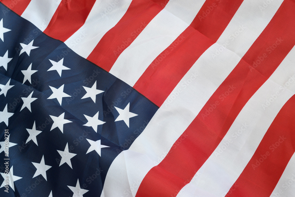 Image of a crumpled American flag with many folds waving in the wind ...