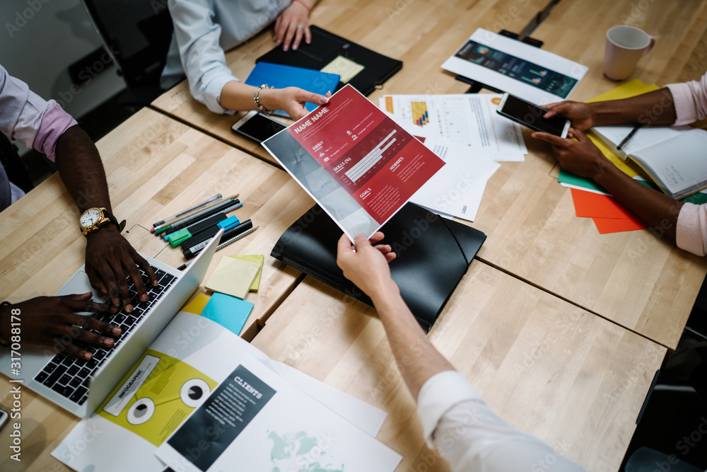 Faceless office employee showing chart to coworkers Stock Photo | Adobe ...