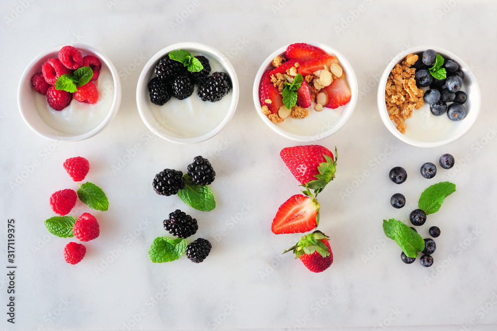 Healthy yogurt bowls with assorted berries and granola. Top view with ...