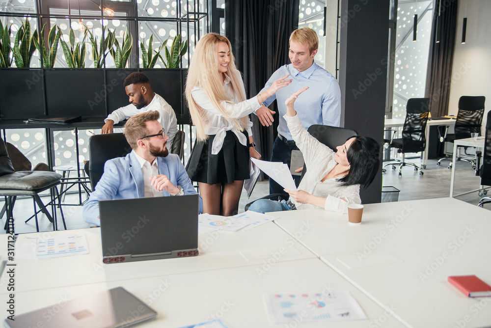 Businessmen greeting their office colleagues with high five before the ...