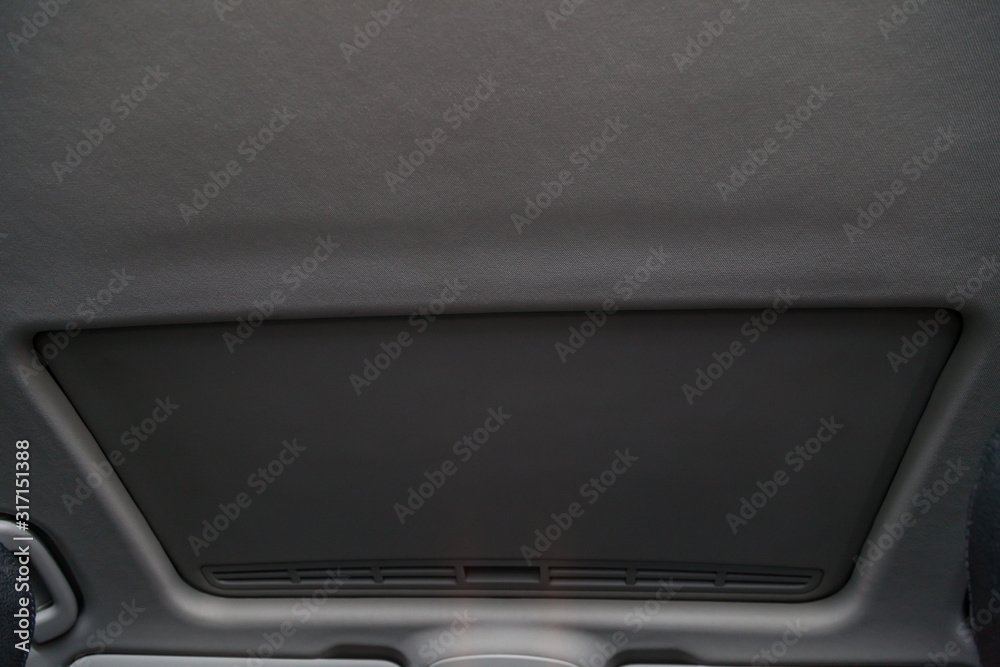 View of the ceiling of the car with a transparent glass hatch for ...