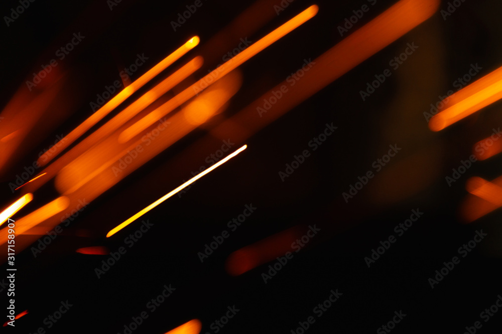 Burning red hot sparks fly from large fire in the night sky. Beautiful ...