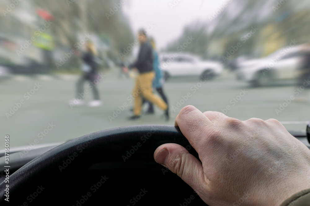 Emergency. View from the car, a man's hand on the steering wheel of the ...