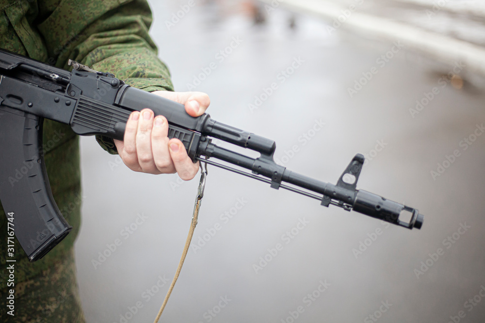The barrel of an assault rifle. The weapon in the hands. Firearms in ...