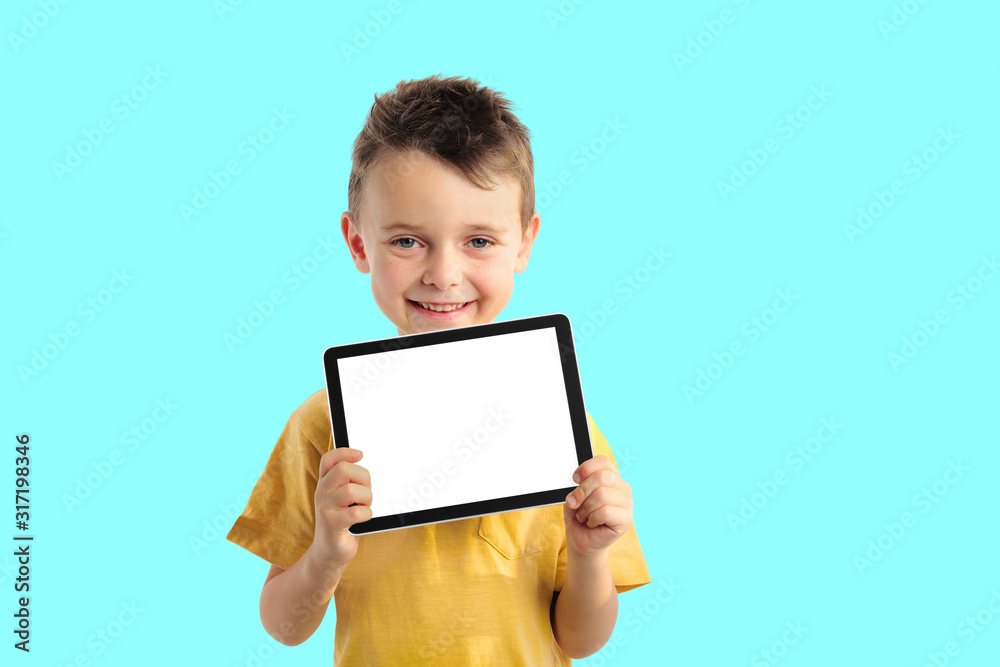 Happy child boy holding a tablet for your information on the blue ...