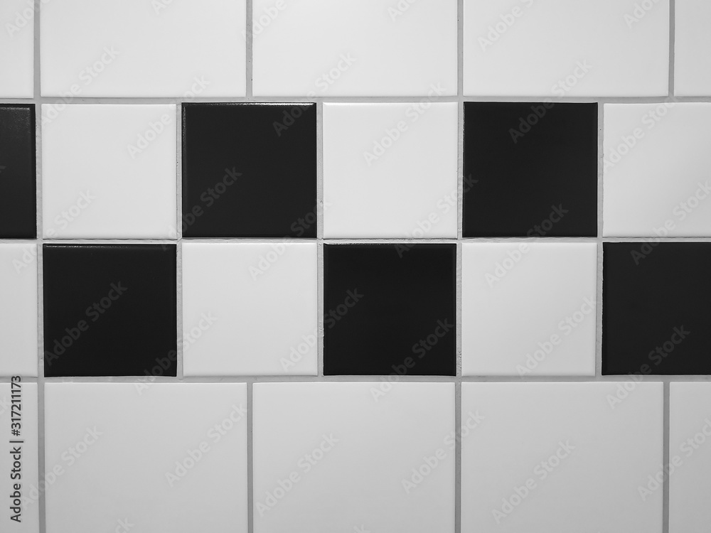 Small square tiles alternately arranged in black and white as a pattern ...