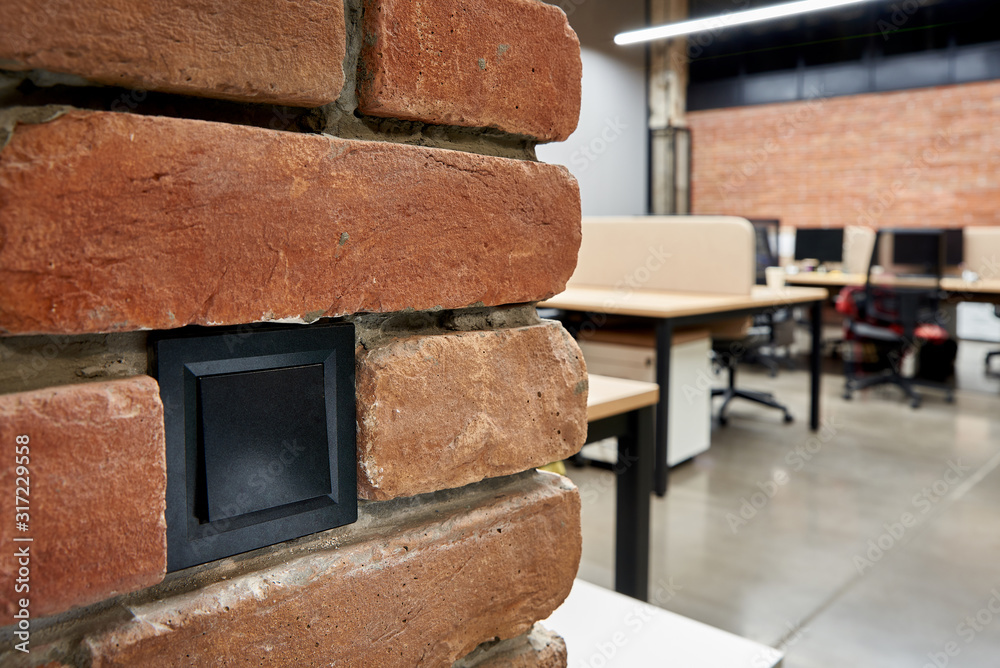 Black switches on a brick wall in a loft style in a large office Stock ...