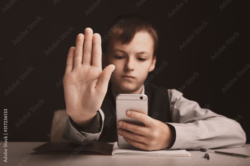 Social cyberbullying concept. Serious kid showing stop sign holding ...