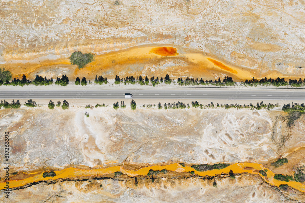 Road in wasteland of Karabash industrial area, aerial top down view ...
