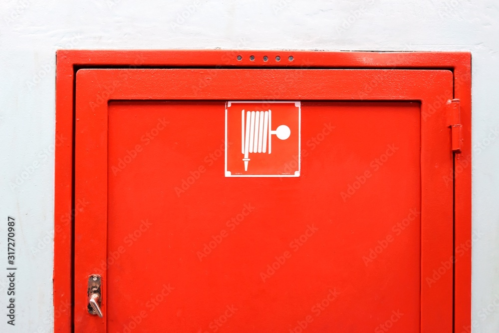 Fire hose sign on the red metal container. Fire hose storage container ...
