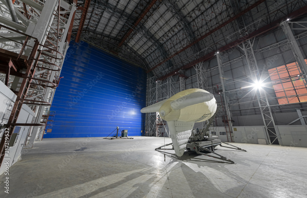 Aerostat on a mobile mooring platform inside an giant airship hangar ...