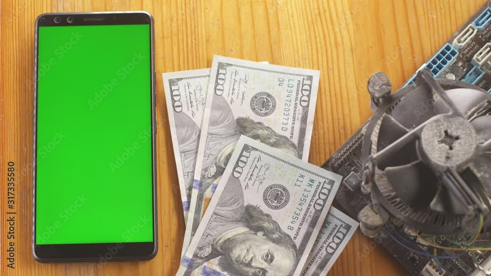 Vídeo do Stock: Man folds hundred dollar bills next to phone ...
