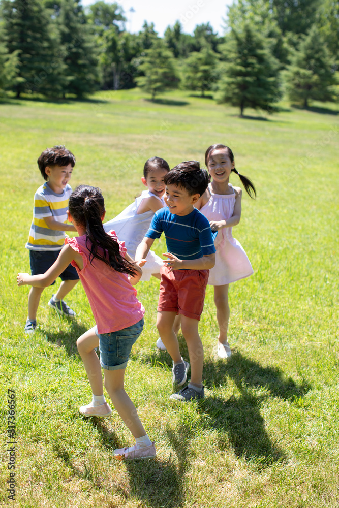 Happy children playing games on meadow Stock Photo | Adobe Stock