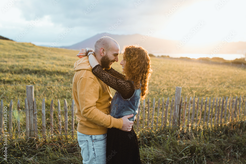 Young bald bearded man in yellow hoodie and jeans shorts embracing ...