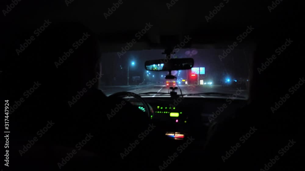 The driver rides at night on a lighted road. The car cracks and ...
