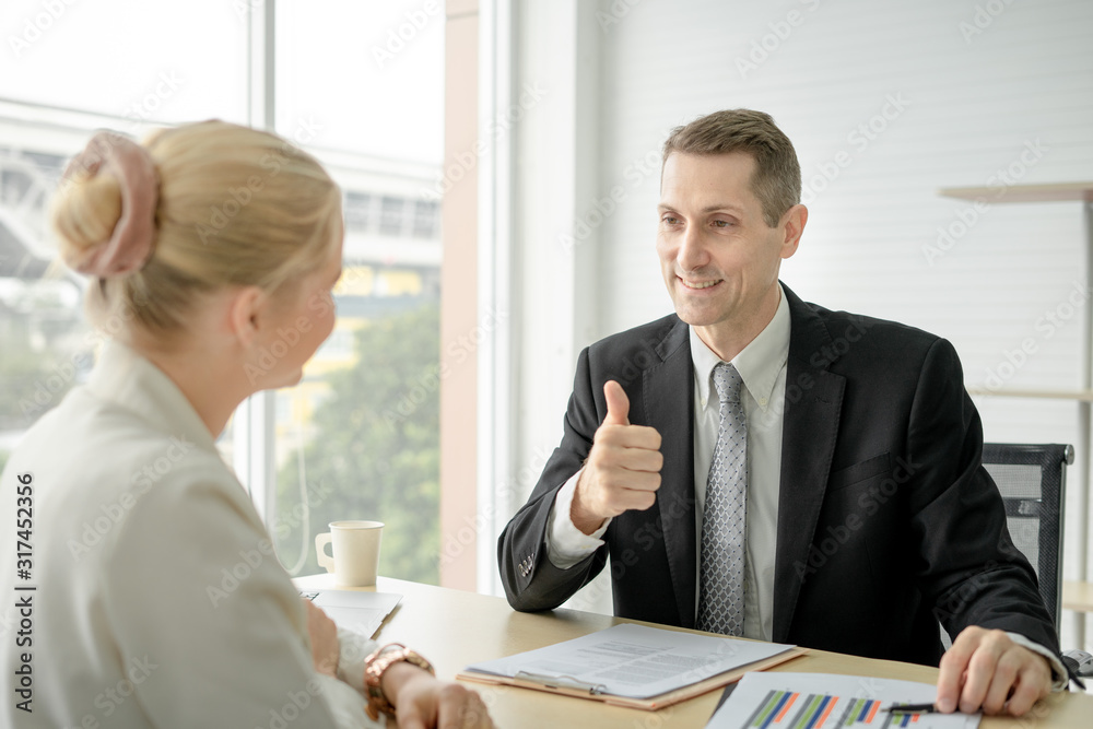 Boss Businessman doing thumbs up congratulation to woman employee at ...