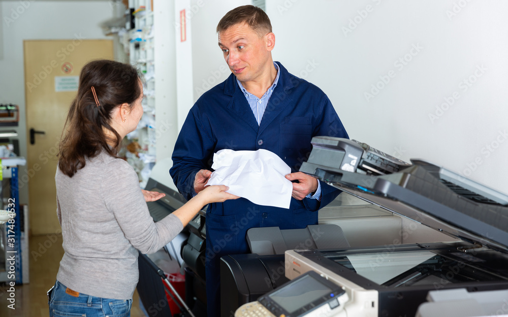 Office employee complains to repairman about poor printer Stock Photo ...