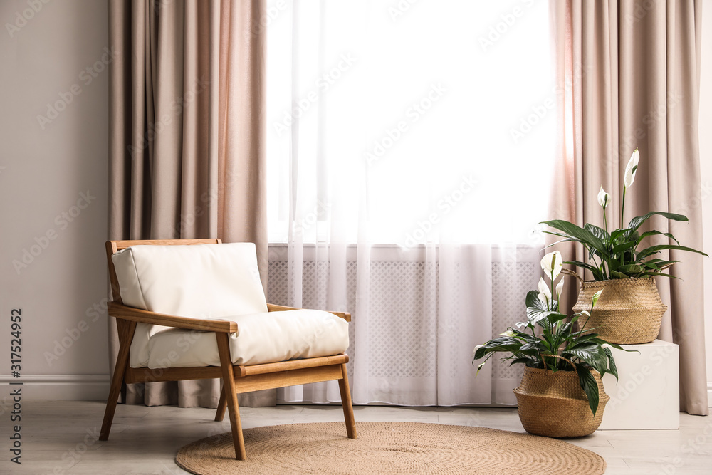 Comfortable armchair near window with elegant curtains in room Stock ...