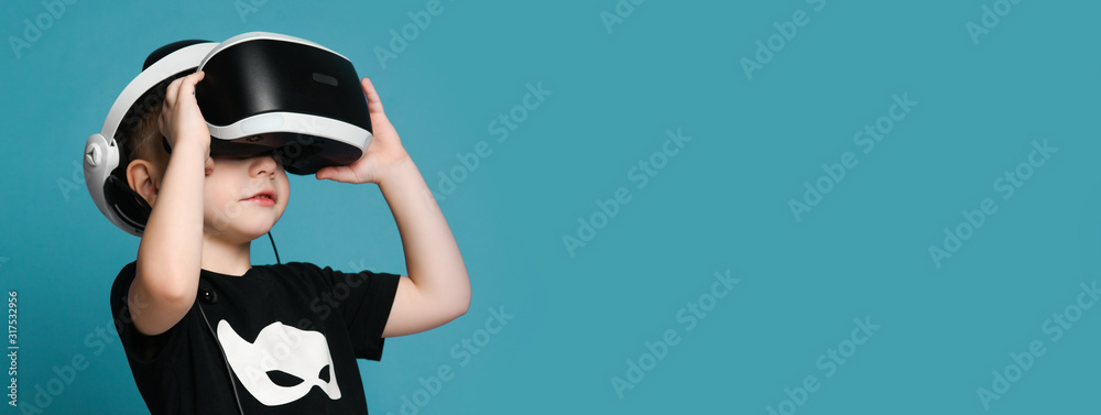 Young boy kid child play virtual reality game in vr glasses and explore ...