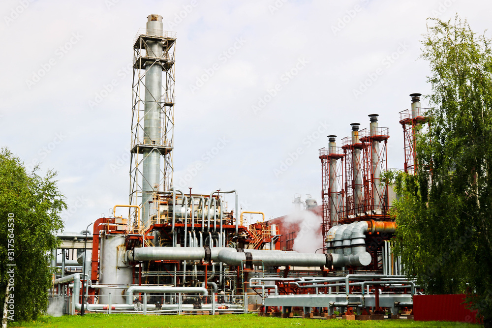 Iron metal industrial plant installations with stairs, fences and pipes ...