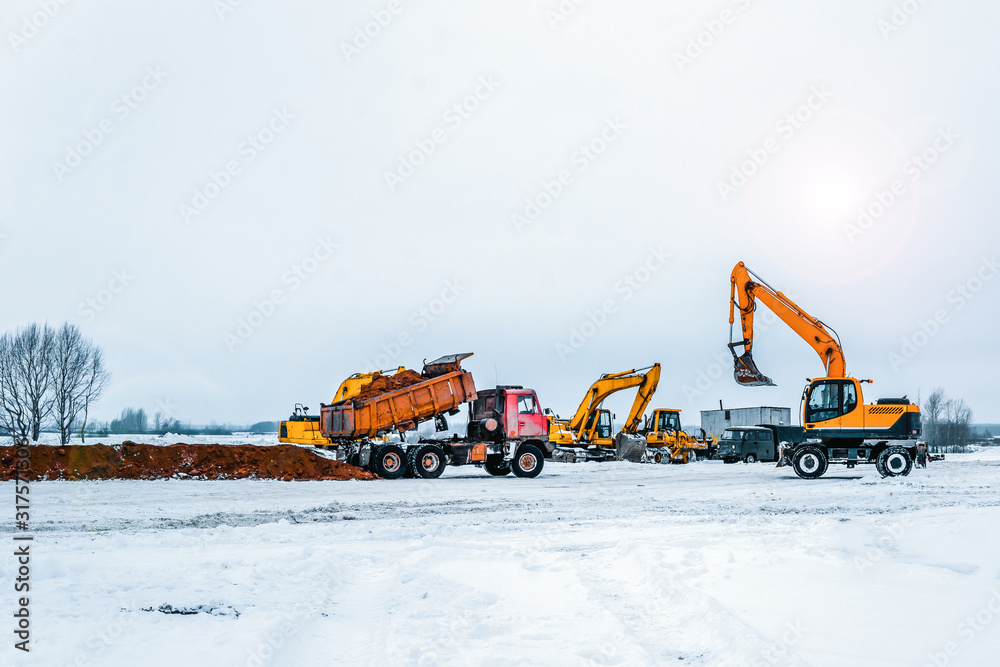 Excavator is loading excavation to the truck. Excavators hydraulic are ...