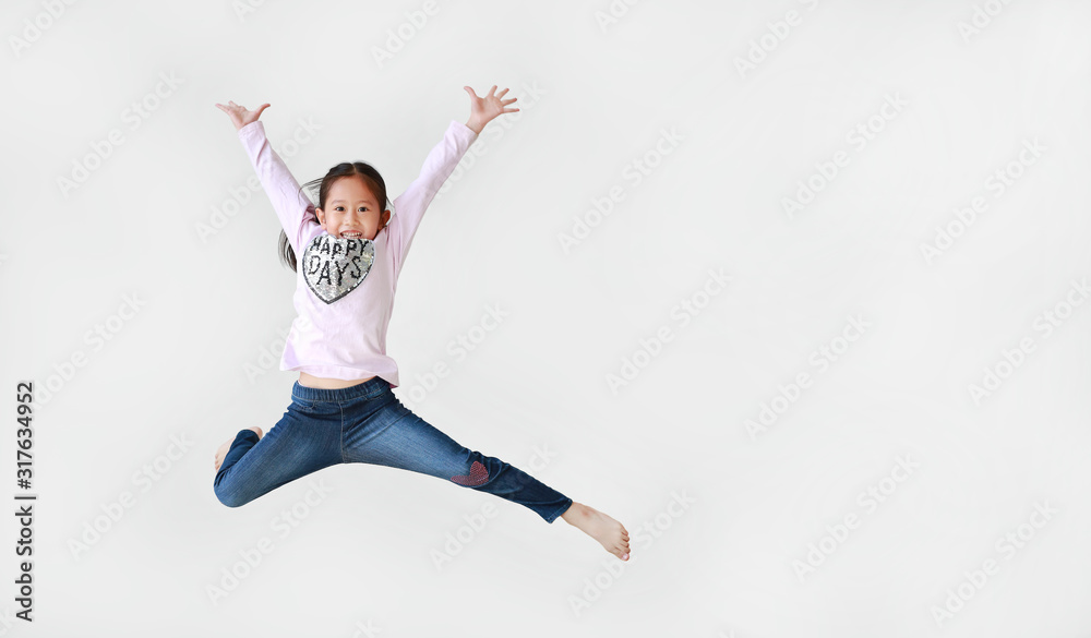 Funny little Asian child girl jumping and freedom movement on air ...