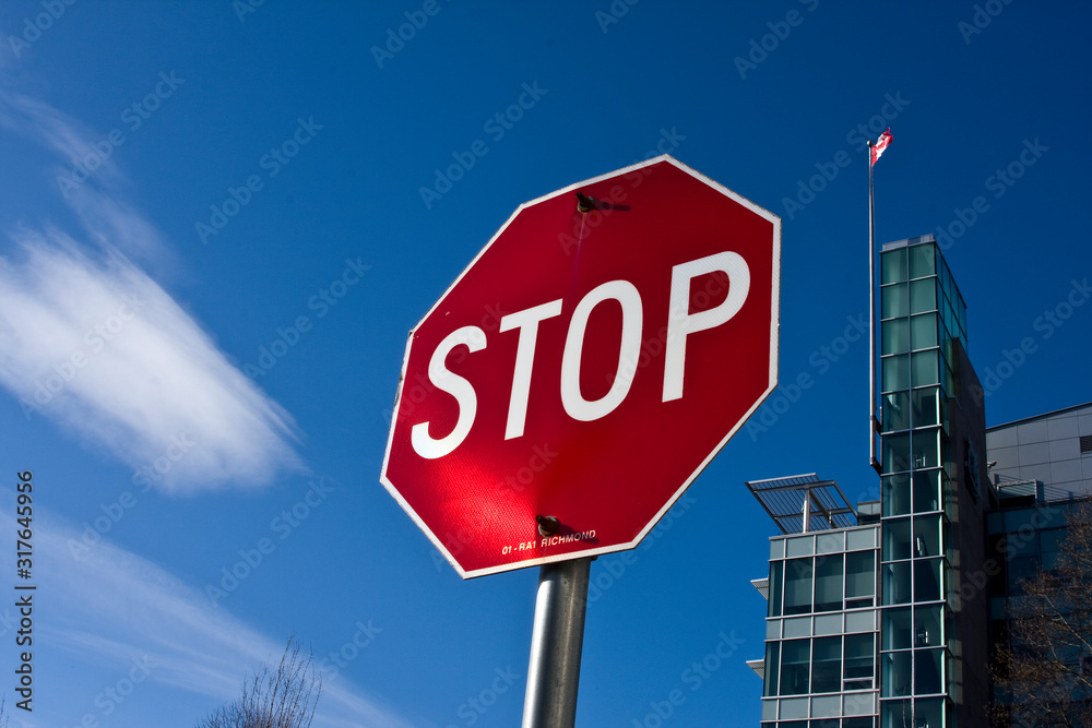 stop sign under Canadian flag Stock Photo | Adobe Stock