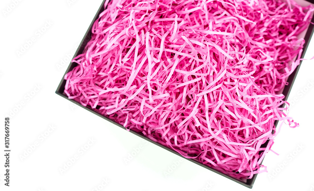 Shredded pink paper packing material in a square box. Pink spaghetti ...