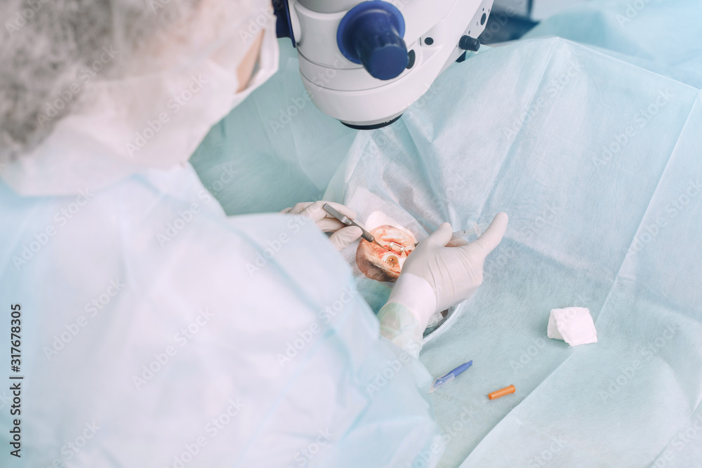 Ophthalmology operation. Surgeon's hands performing laser eye vision ...