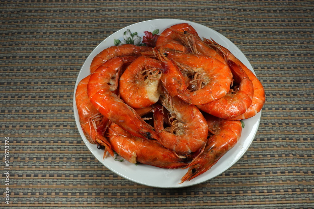 Baked shrimp or boiled prawn with shell on the plate. Famous ...