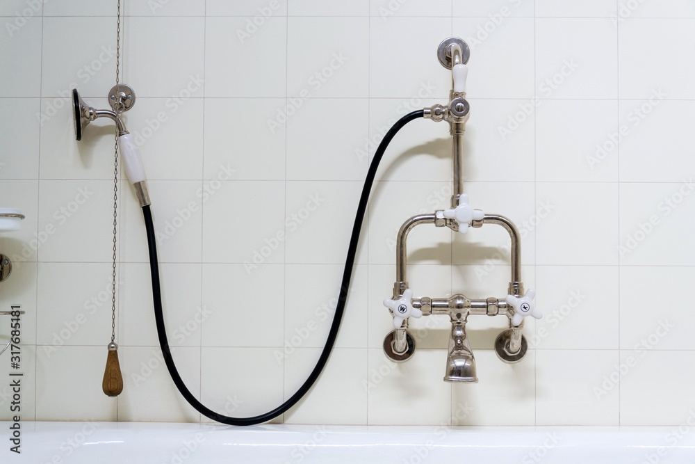 Beautiful shower bath with hot and cold water taps, white tile design ...