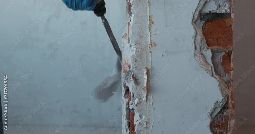 Close-up of plastered brick wall, plaster cut off with jackhammer ...