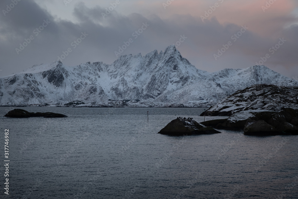typical lofoten islands view. fishin town with mountains in backround ...