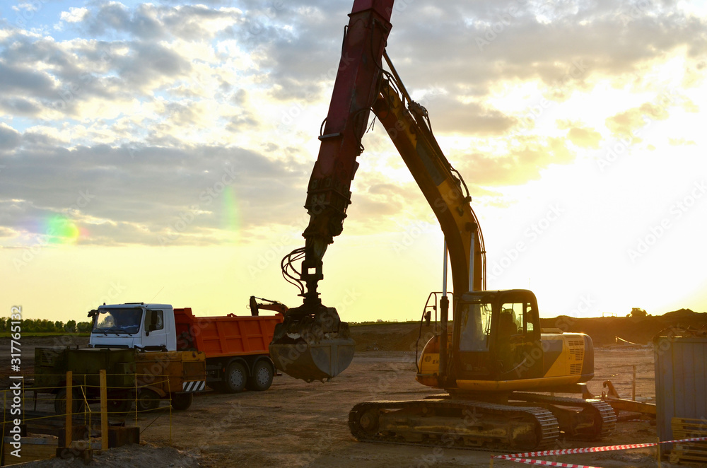 Excavator with grab bucket and telescopic boom for deep digging in the ...