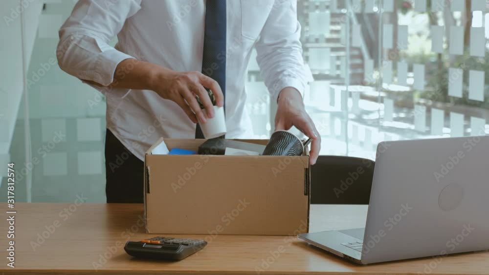 Business man stressing with resignation letter for quit a job packing ...